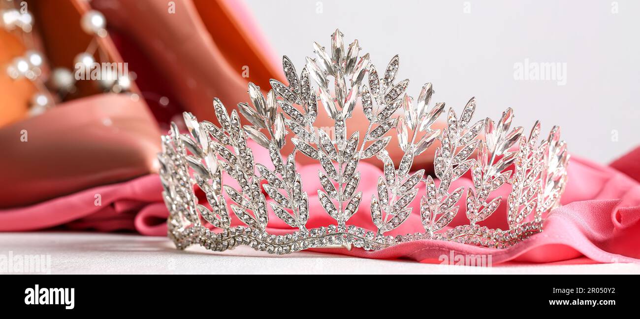 Beautiful tiara with prom dress on light background Stock Photo - Alamy