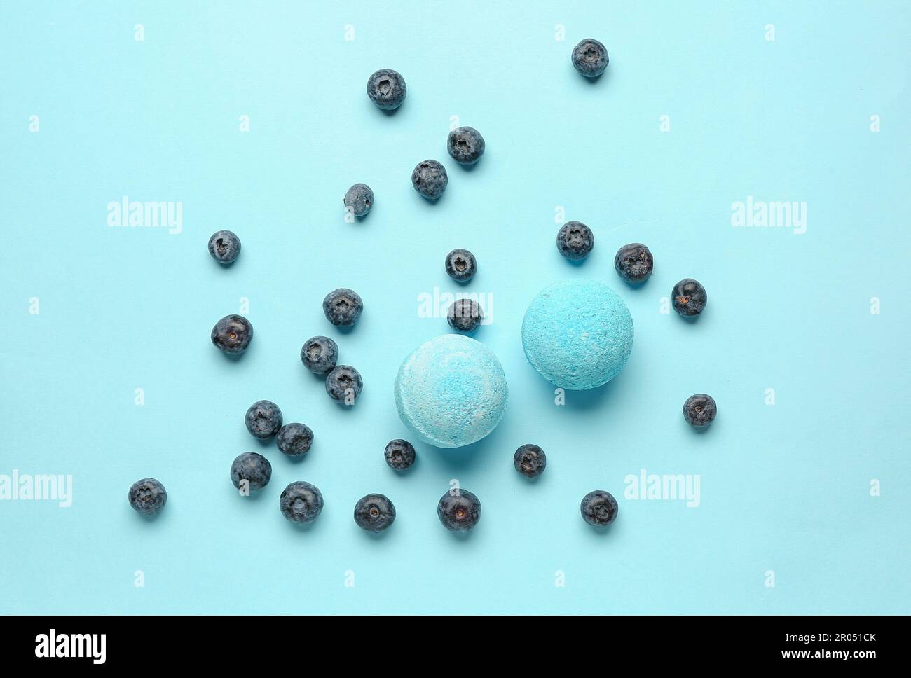 Bath bombs with blueberry on blue background Stock Photo - Alamy