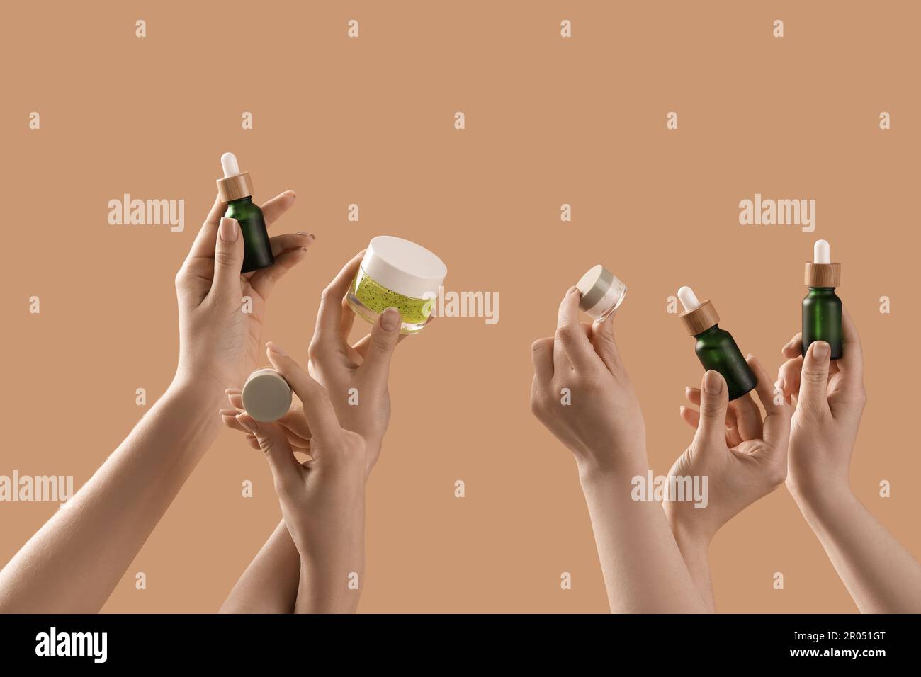 Hands holding different cosmetic products on beige background Stock ...