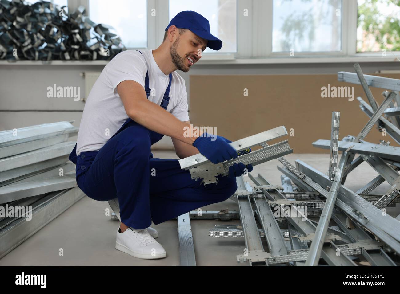 Construction worker with used building materials in room prepared for ...