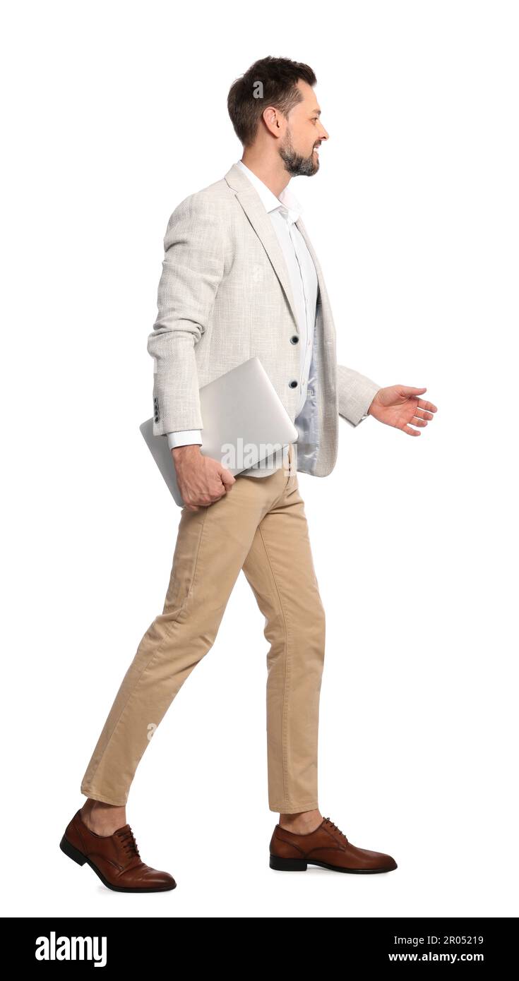 Man with laptop walking on white background Stock Photo - Alamy