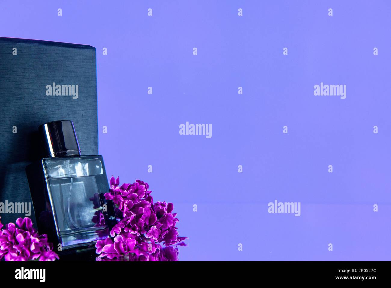front view expensive perfume with flowers on purple background ...