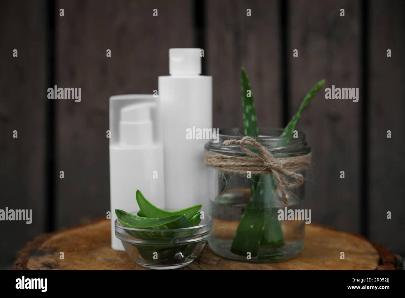 Green aloe vera leaves with cosmetics on stump Stock Photo - Alamy