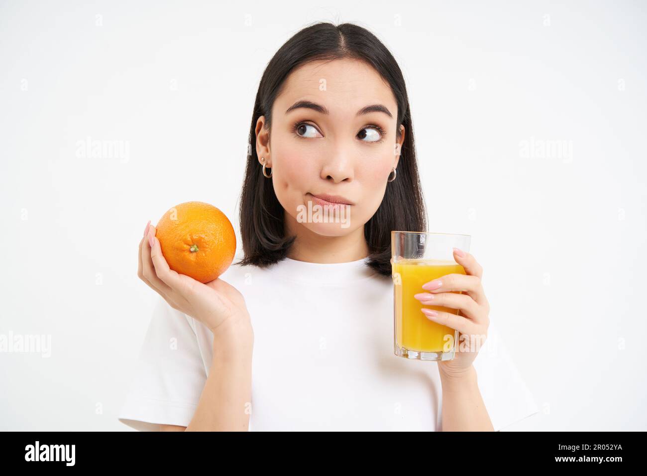 Close up portrait of asian woman with orange and glass of juice ...