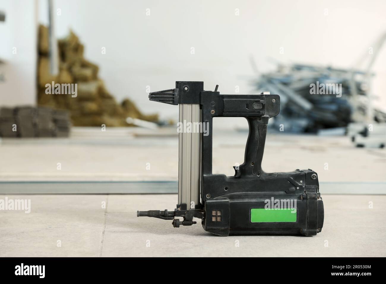Gas gun on floor indoors. Home renovation Stock Photo - Alamy