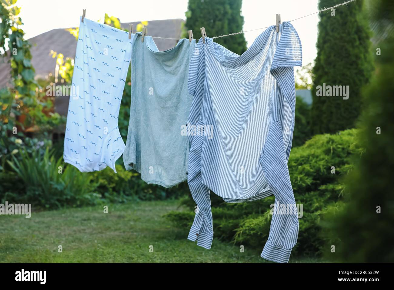 Shirts drying on washing line at backyard of house Stock Photo - Alamy