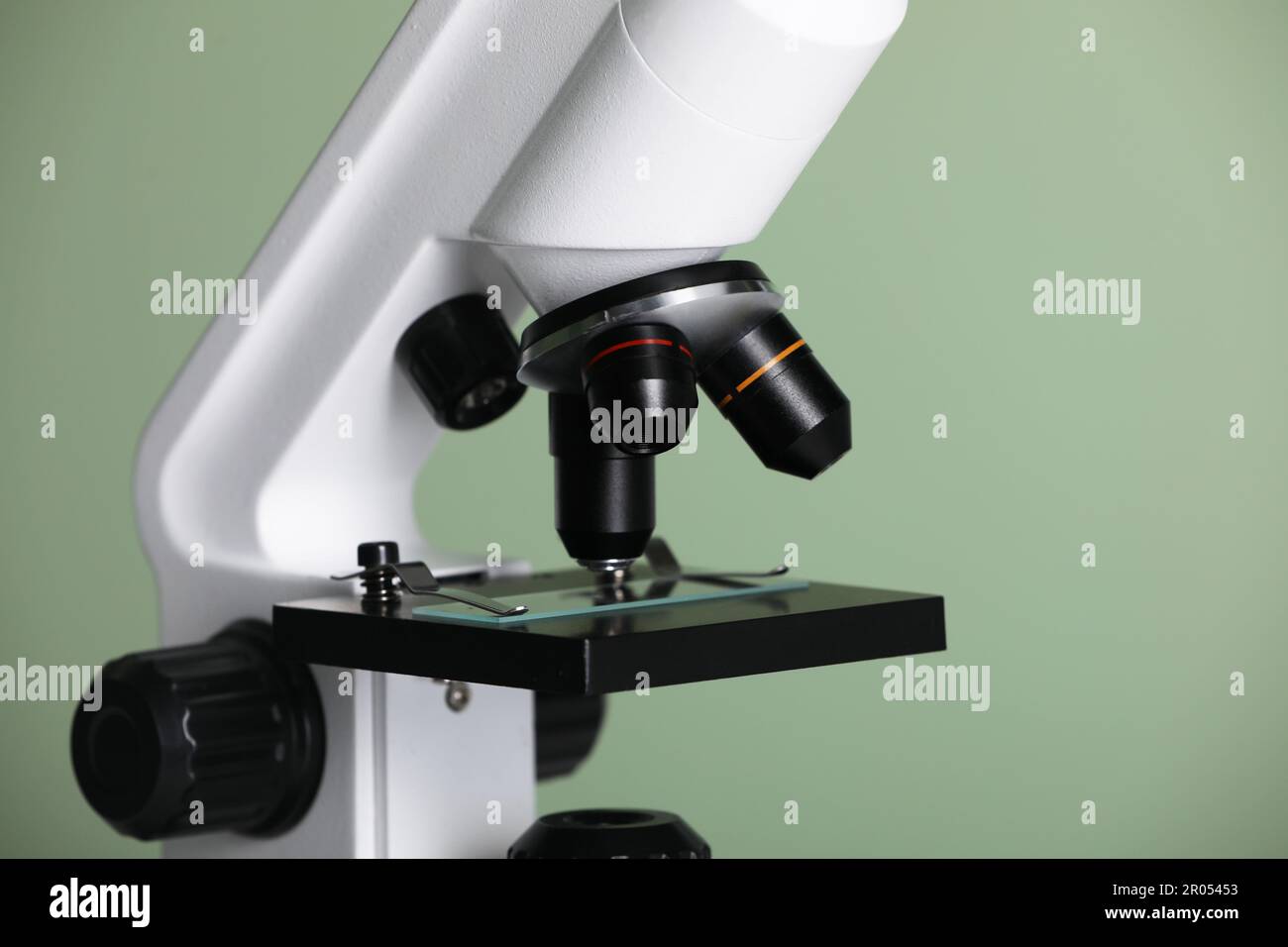 Modern microscope on green background, closeup. Medical equipment Stock ...