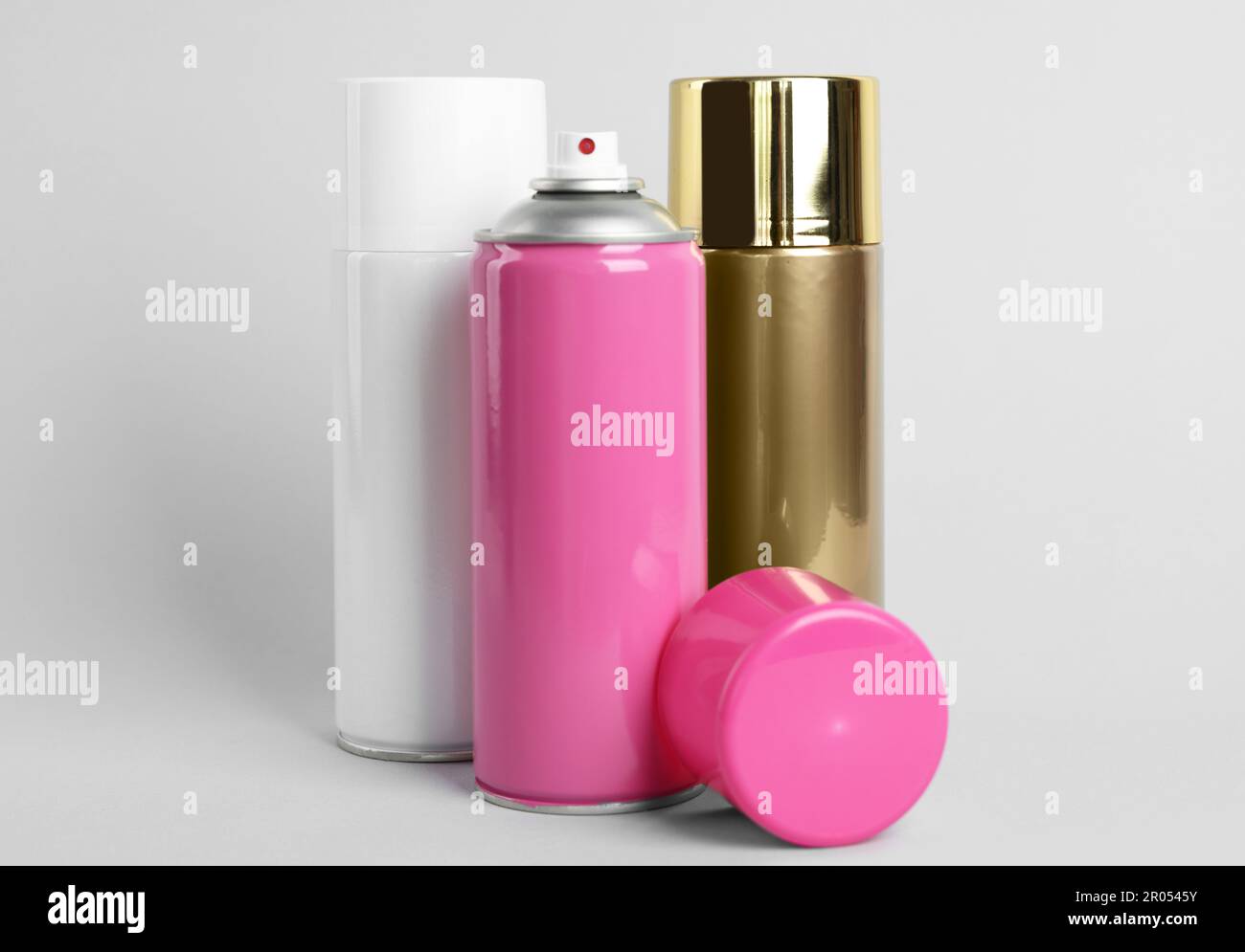 Colorful cans of spray paints on light grey background Stock Photo - Alamy