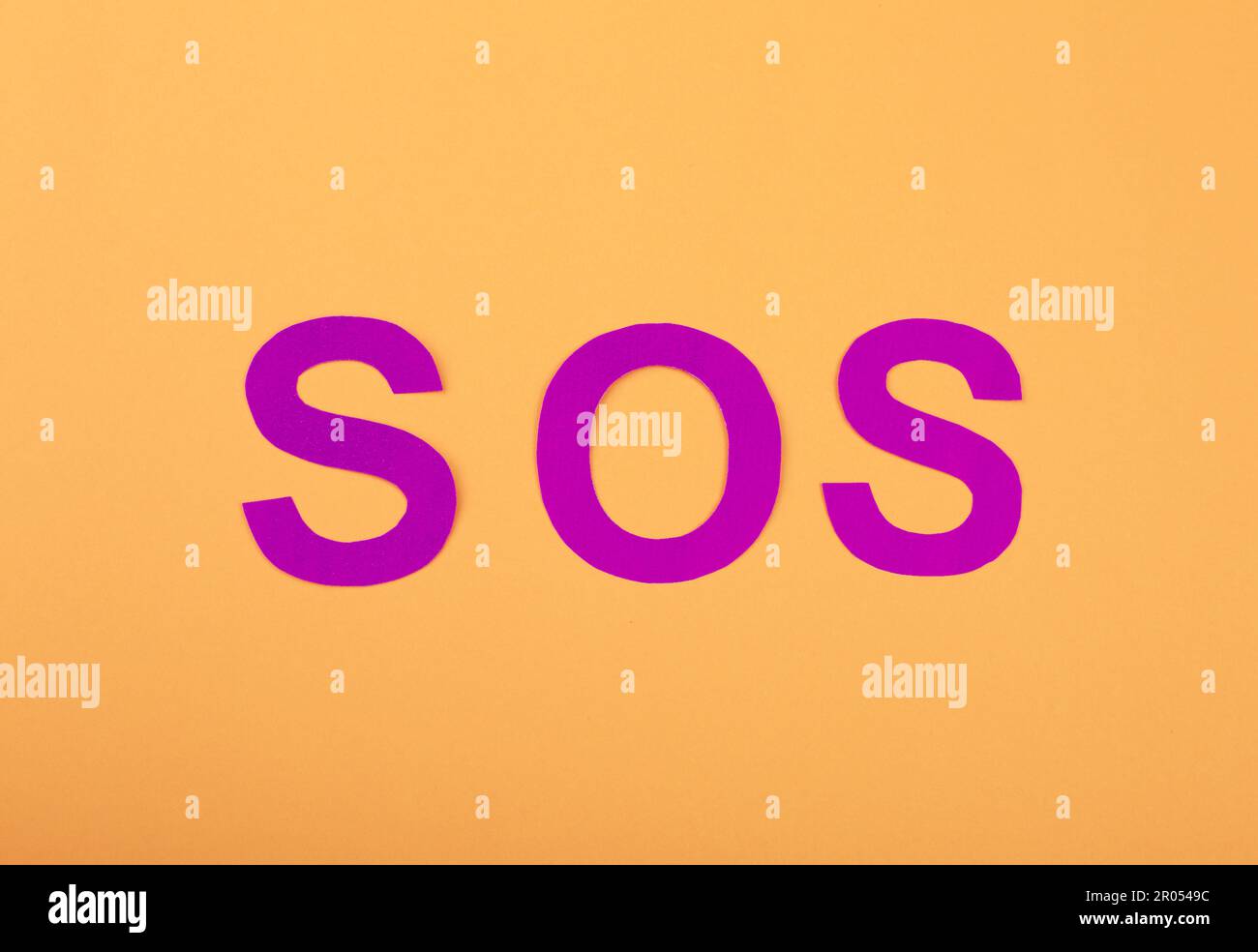 Abbreviation SOS made of paper letters on orange background, top view ...