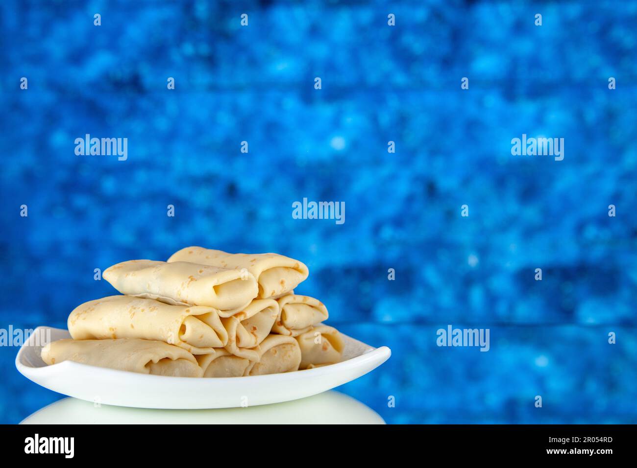 front view rolled sweet pancakes inside plate on light background ...