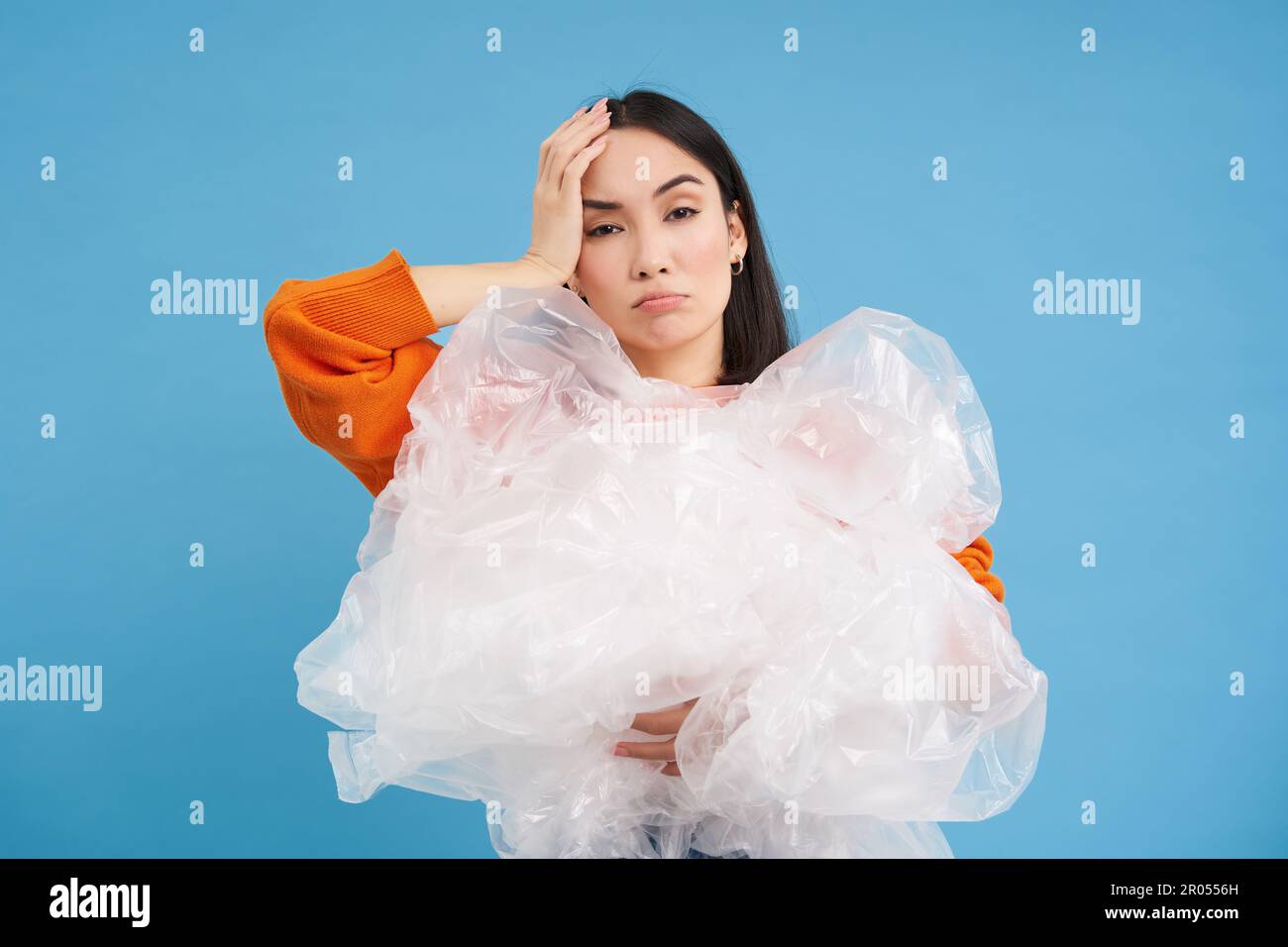 Eco activism and recycling. Young asian woman with bothered face, tired ...