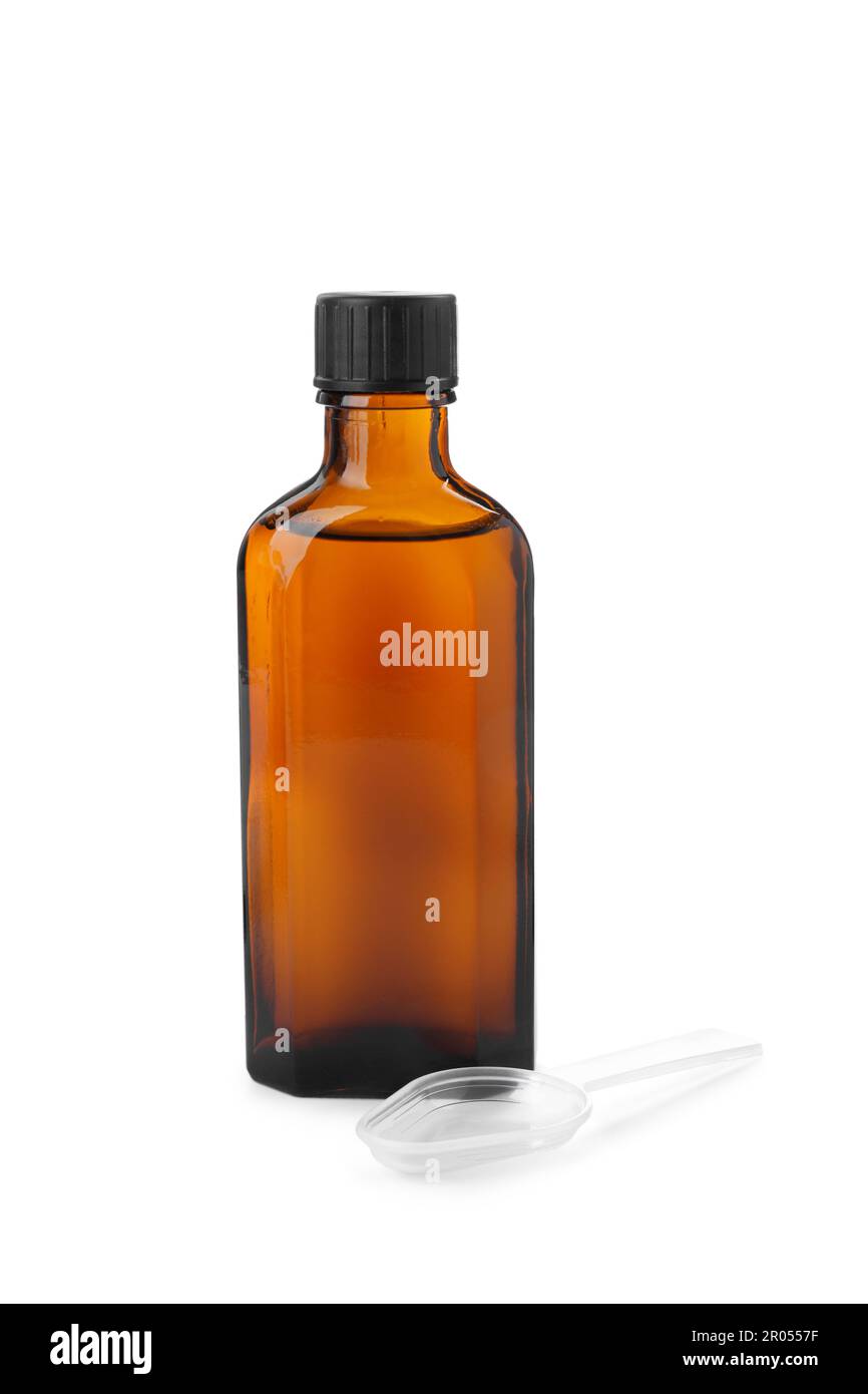 Bottle of syrup with plastic spoon on white background. Cough and cold ...
