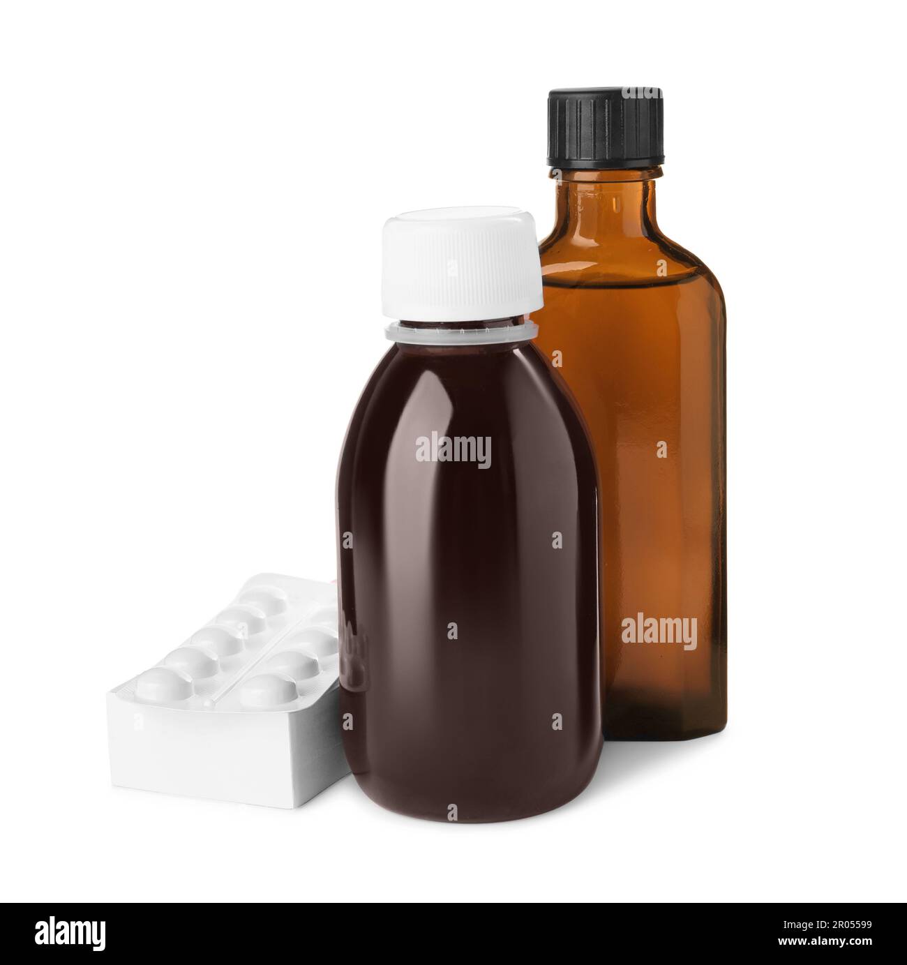 Bottles of syrups with pills on white background. Cough and cold ...