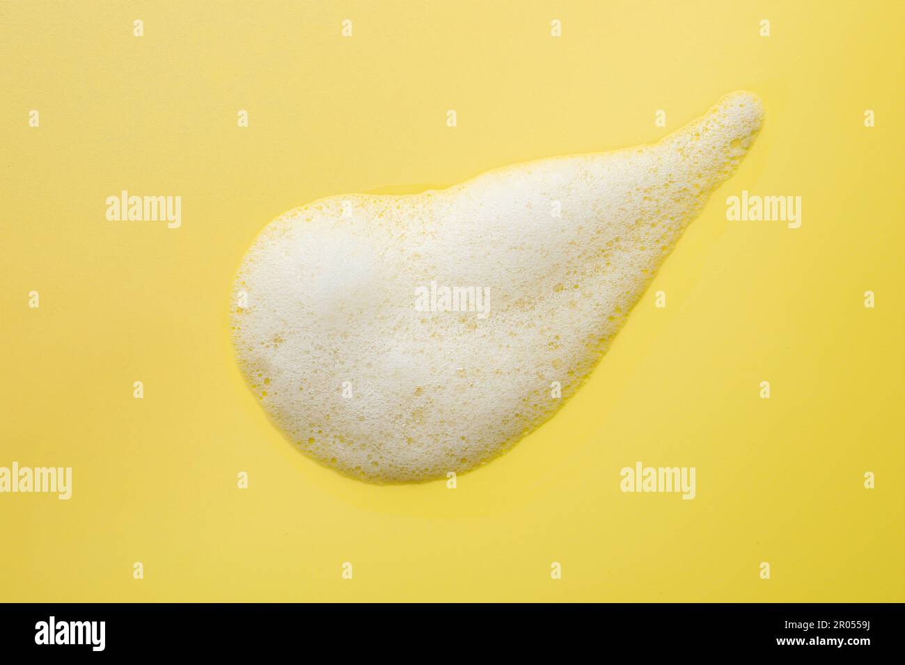 Drop of fluffy soap foam on yellow background, top view Stock Photo - Alamy