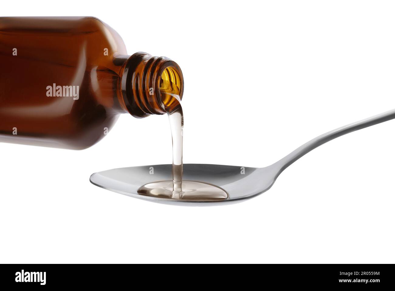 Pouring syrup into spoon from bottle isolated on white, closeup. Cough ...