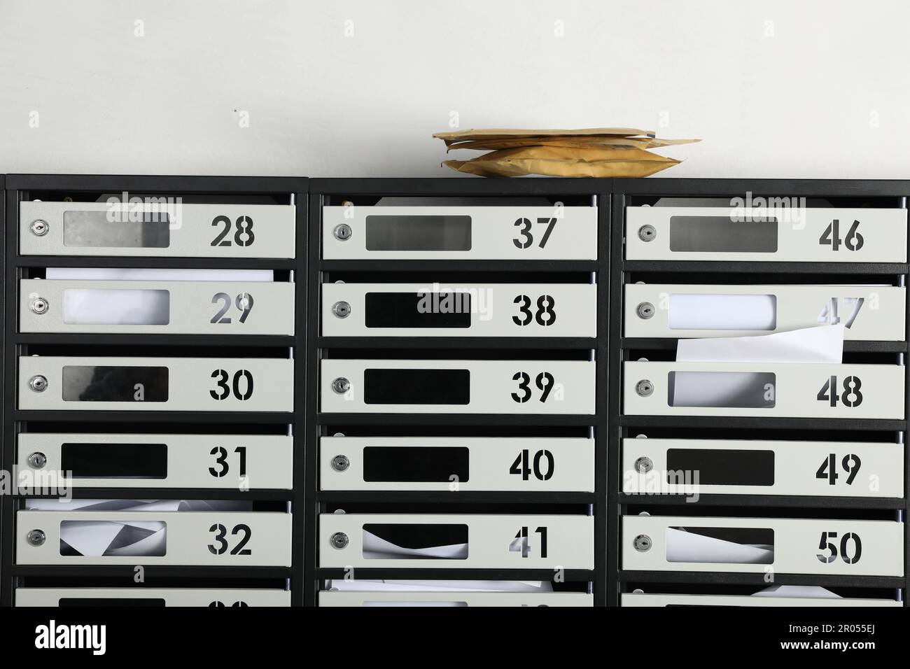 New mailboxes with keyholes, numbers, receipts and envelopes in post ...