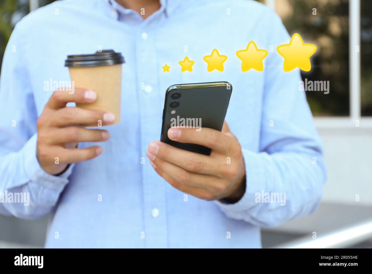 Man with smartphone giving feedback outdoors, closeup. Customer review ...