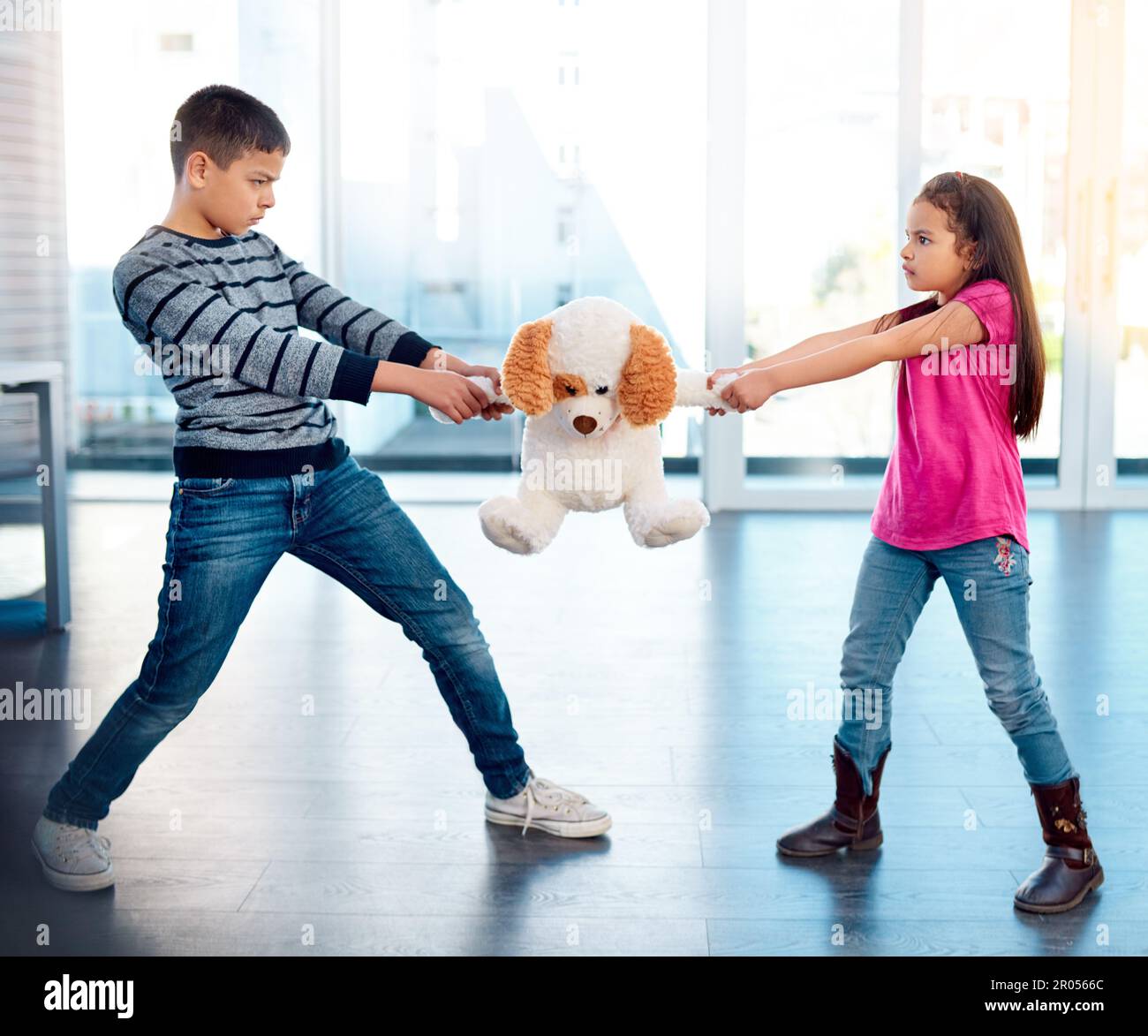 Tug of war alert. Full length shot of two young children fighting over ...