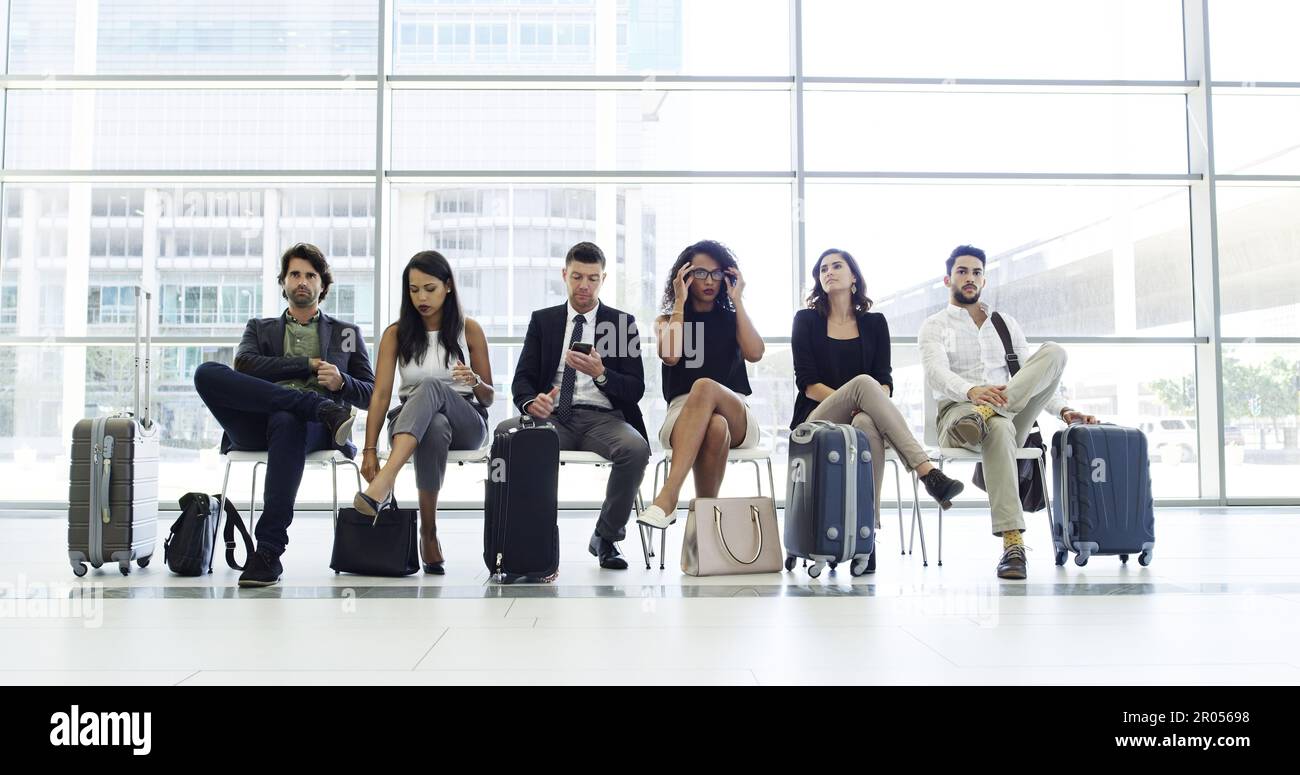 Waiting for their boarding call. Full length shot of a group of ...