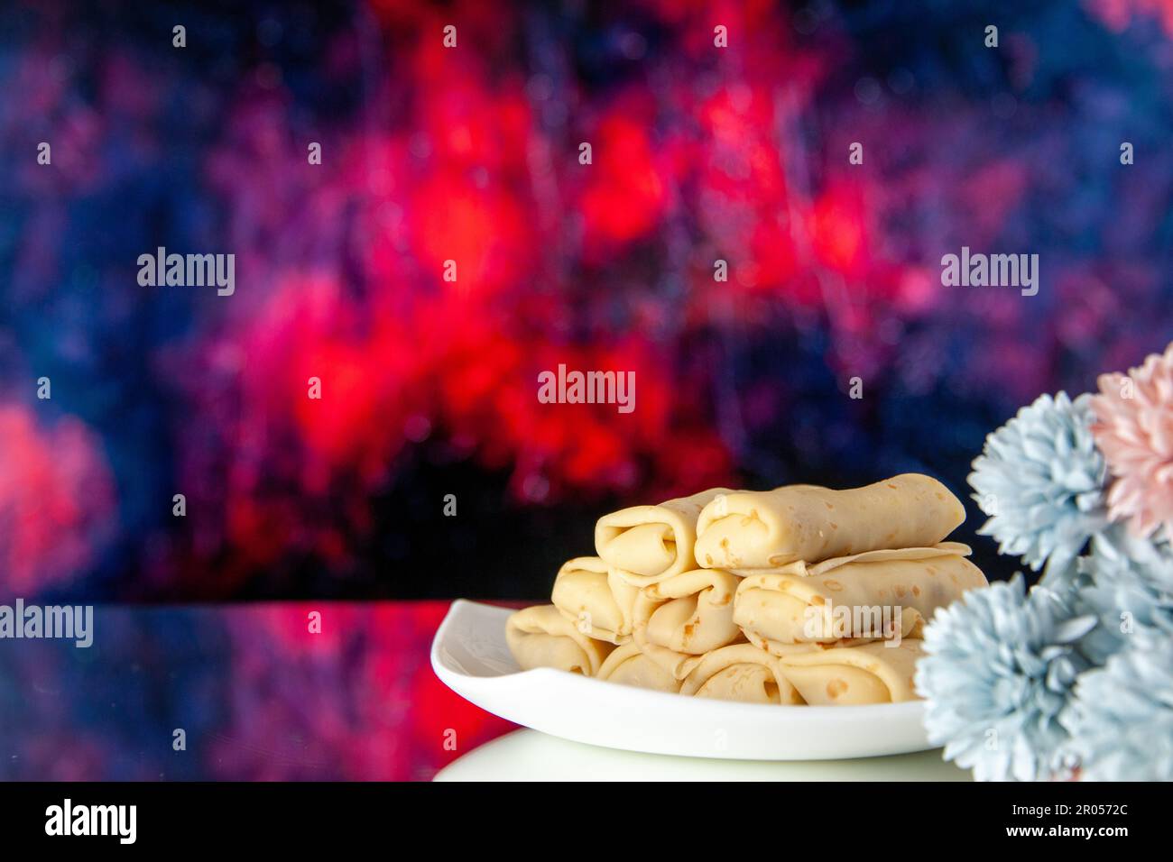 front view yummy rolled pancakes on dark red background milk breakfast ...