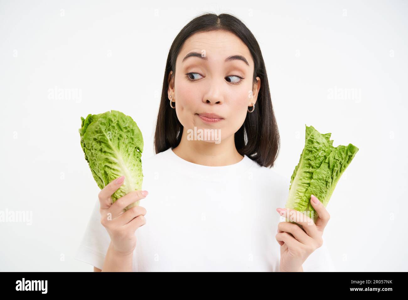 Healthy diet and organic food. Smiling asian woman showing cabbage ...