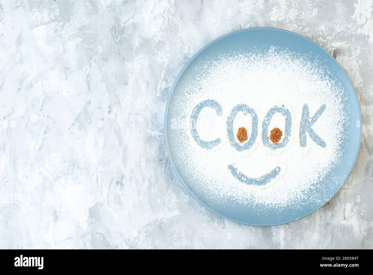 top view white flour making cook writing inside plate on white ...