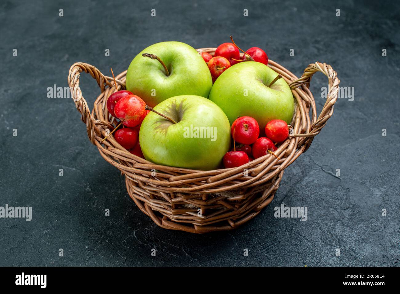 front view basket with fruits apples and sweet cherries on dark ...