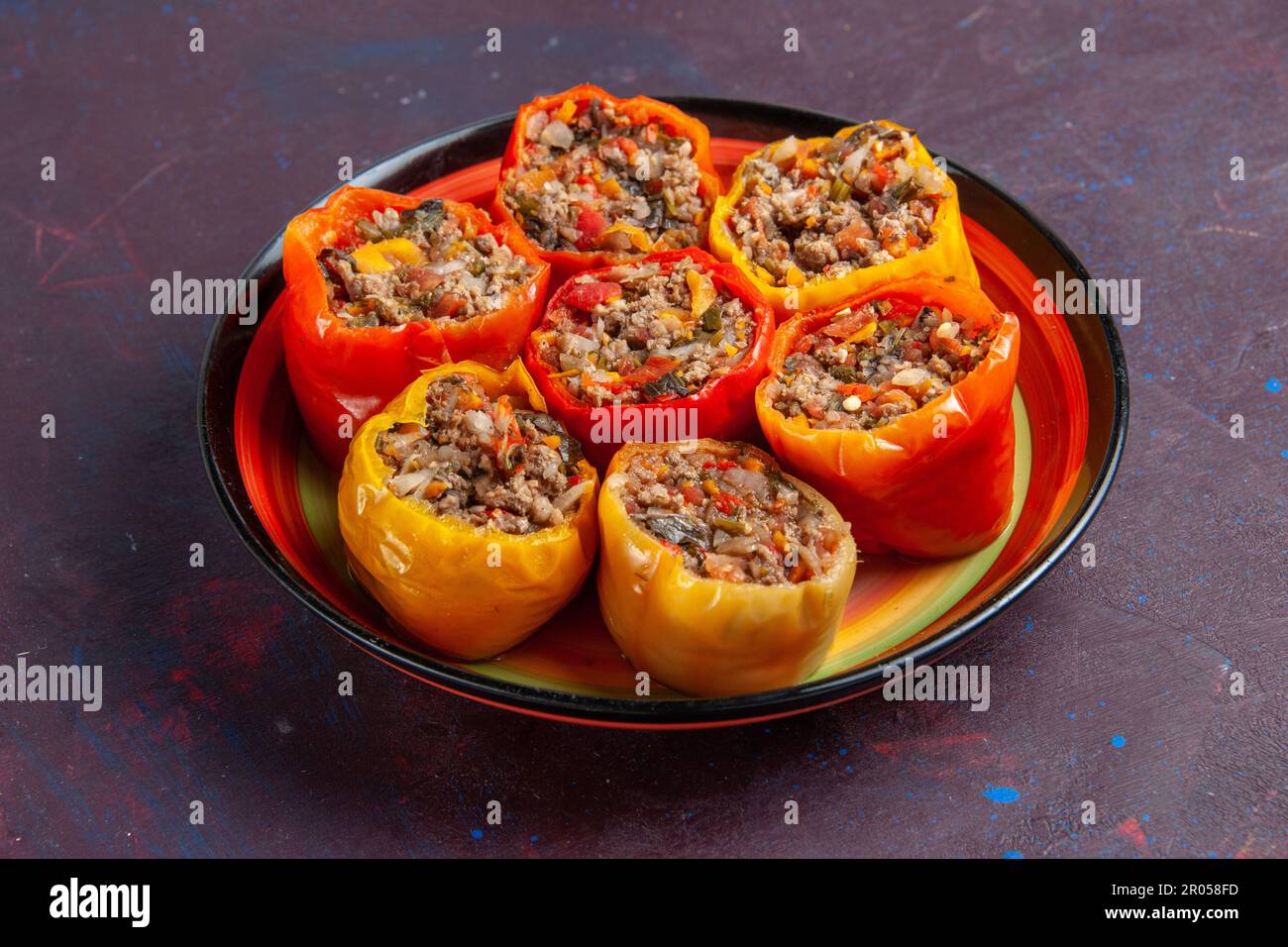 front view cooked bell-peppers with ground meat on the dark grey ...