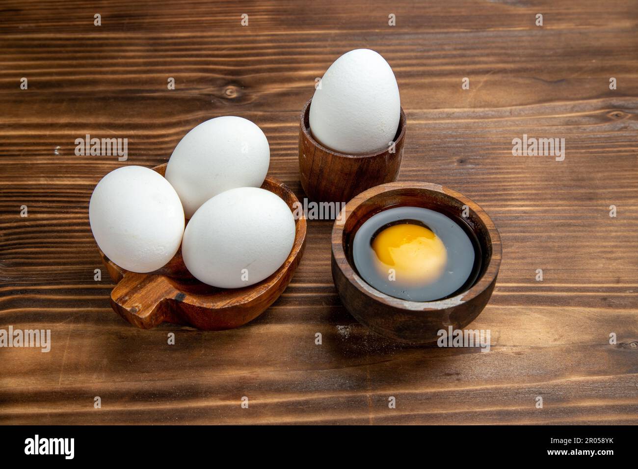 front view raw eggs whole products on brown wooden background egg food ...