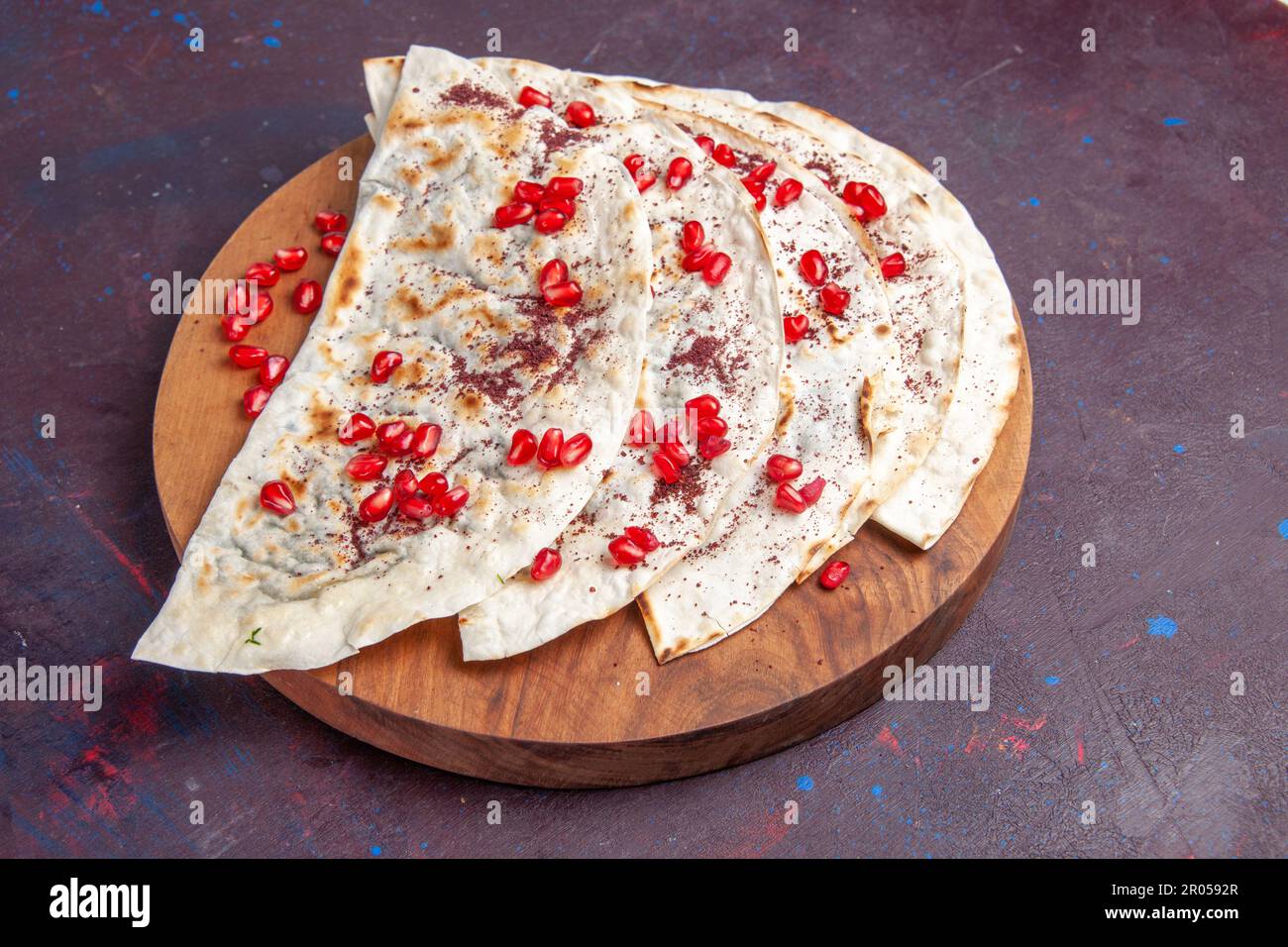 half-top view delicious meat qutabs pitas with fresh red pomegranates ...