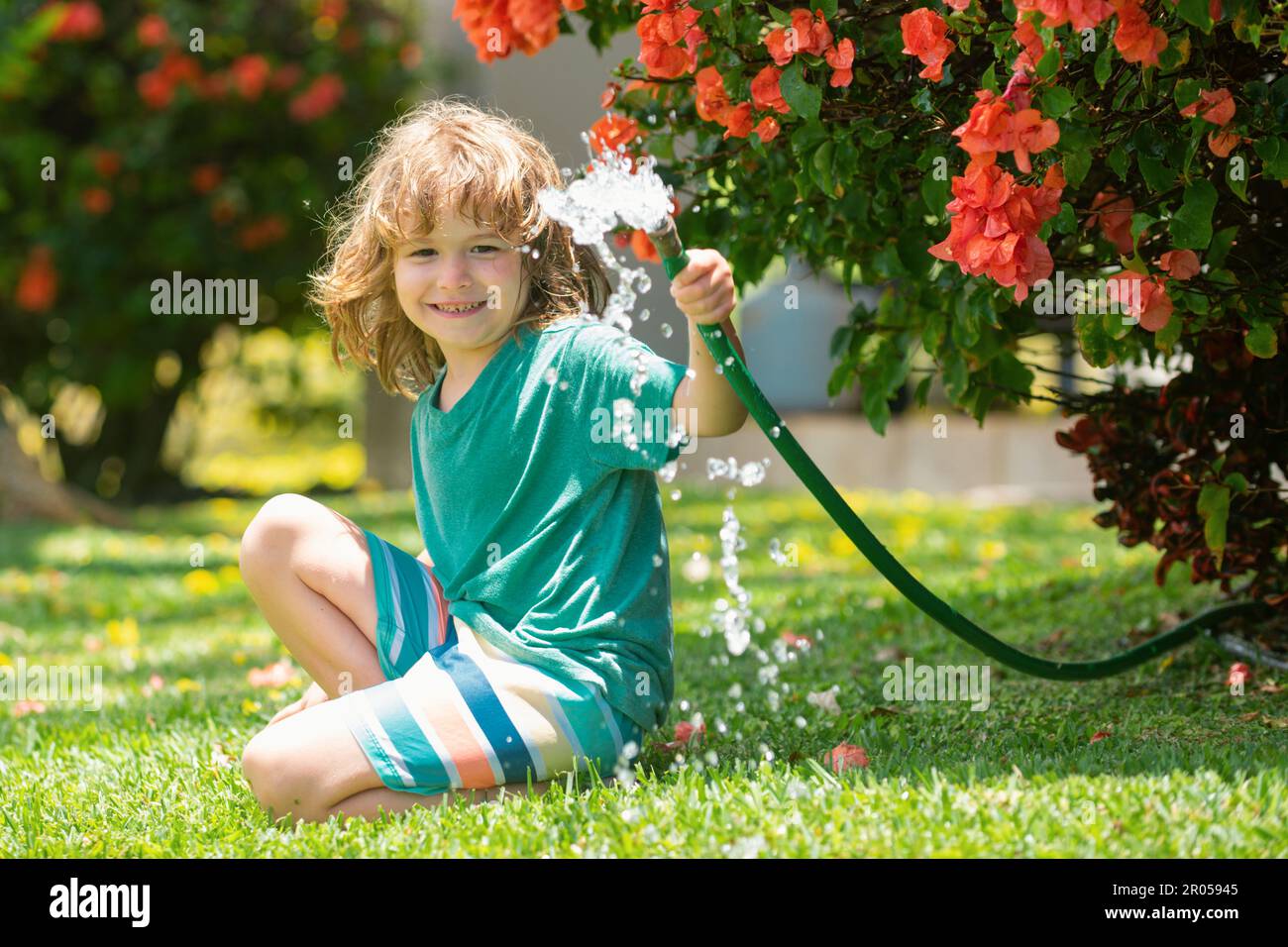 Kids play with water garden hose in yard. Outdoor children summer fun ...