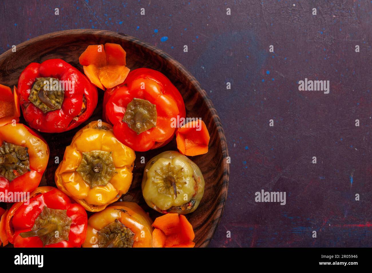 top close view cooked bell-peppers with ground meat inside on grey ...