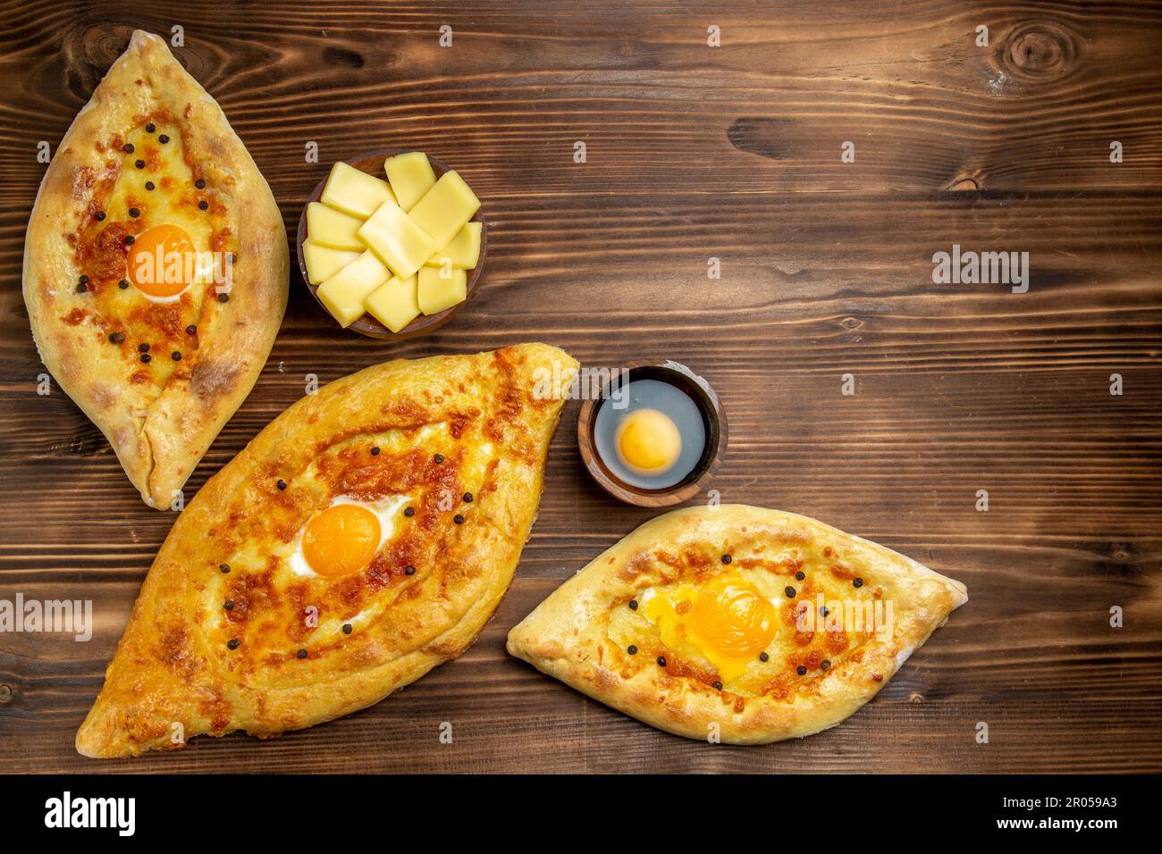top view baked egg breads fresh off the oven on brown wooden desk dough ...