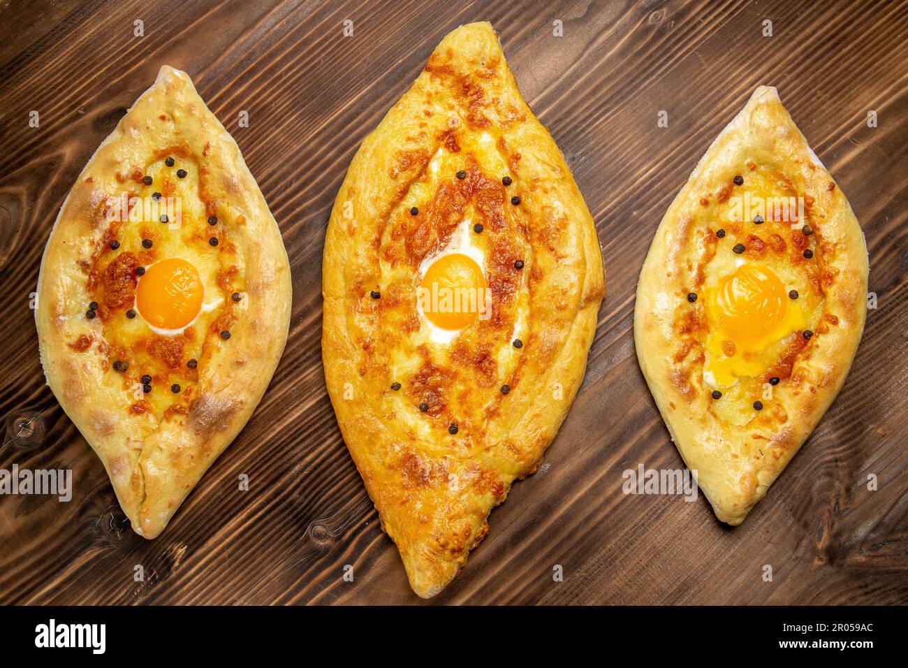 top view baked egg breads fresh off the oven on brown desk dough egg ...