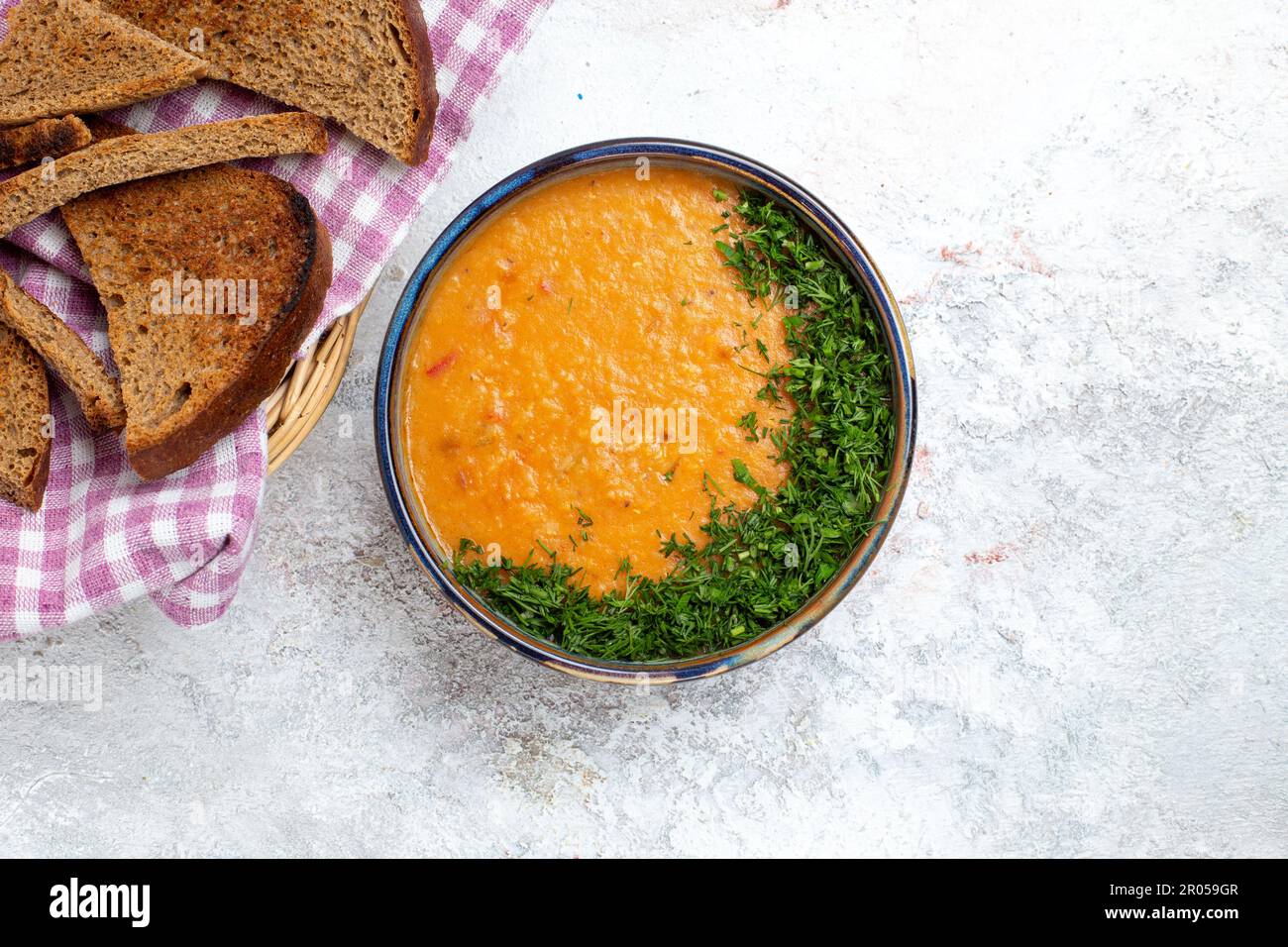 top view bean soup called merci with bread loafs on a white background ...