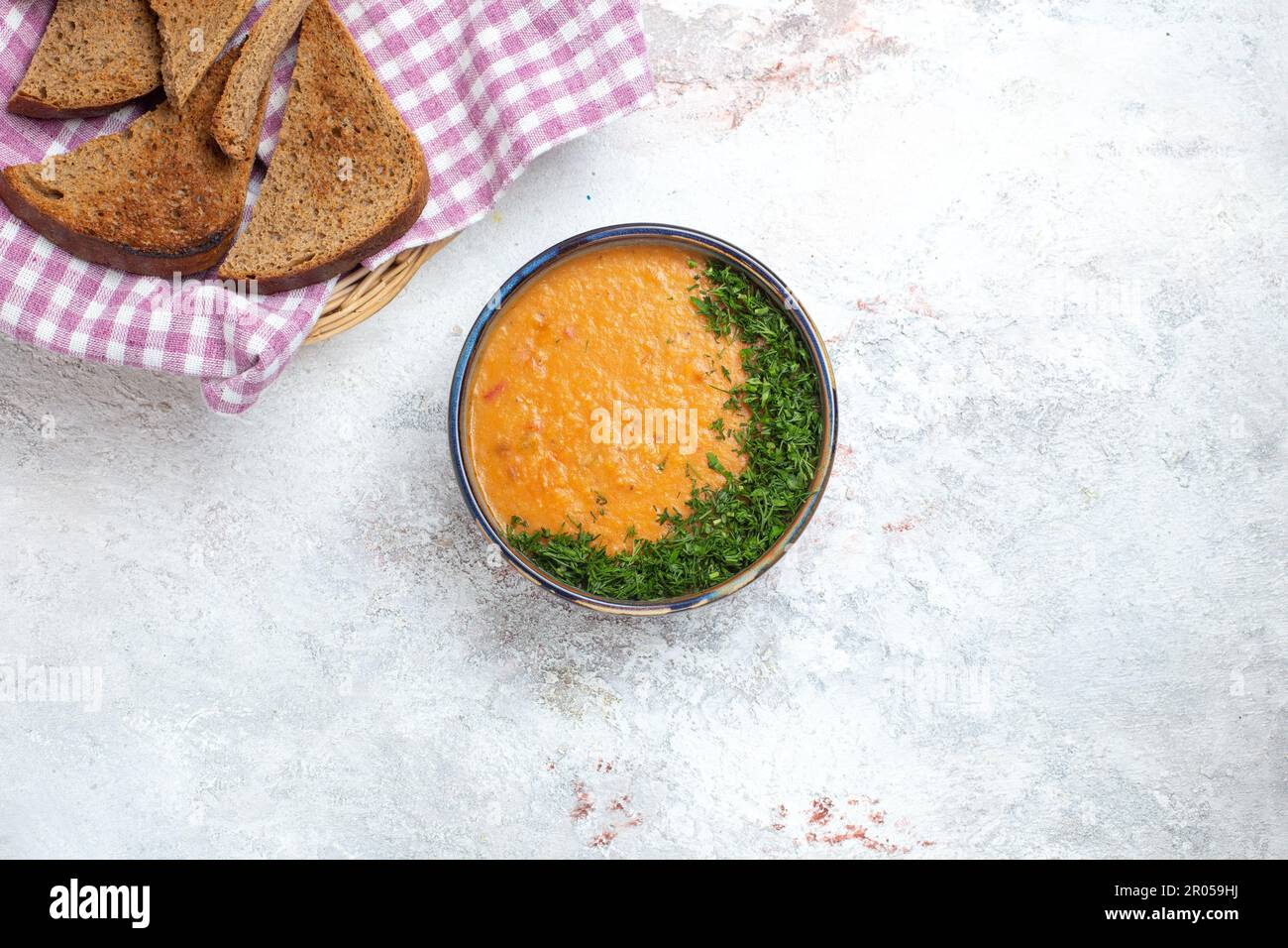 top view bean soup called merci with bread loafs on white background ...