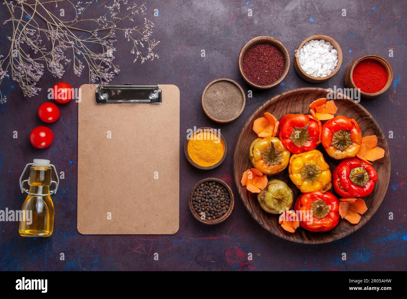 top view cooked bell-peppers with different seasonings on dark grey ...