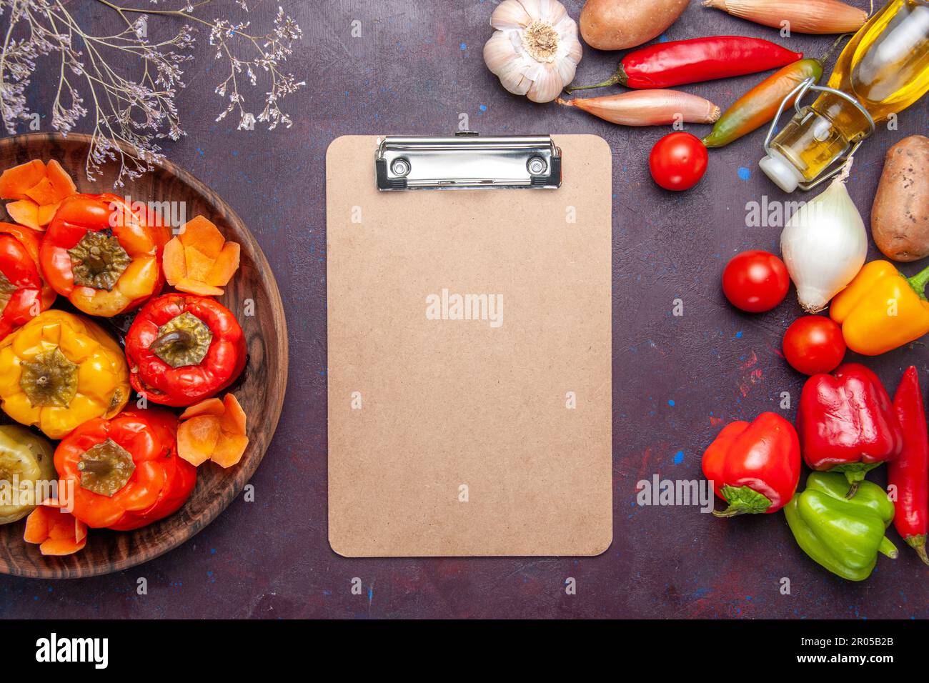 top view cooked bell-peppers with fresh vegetables on the dark ...