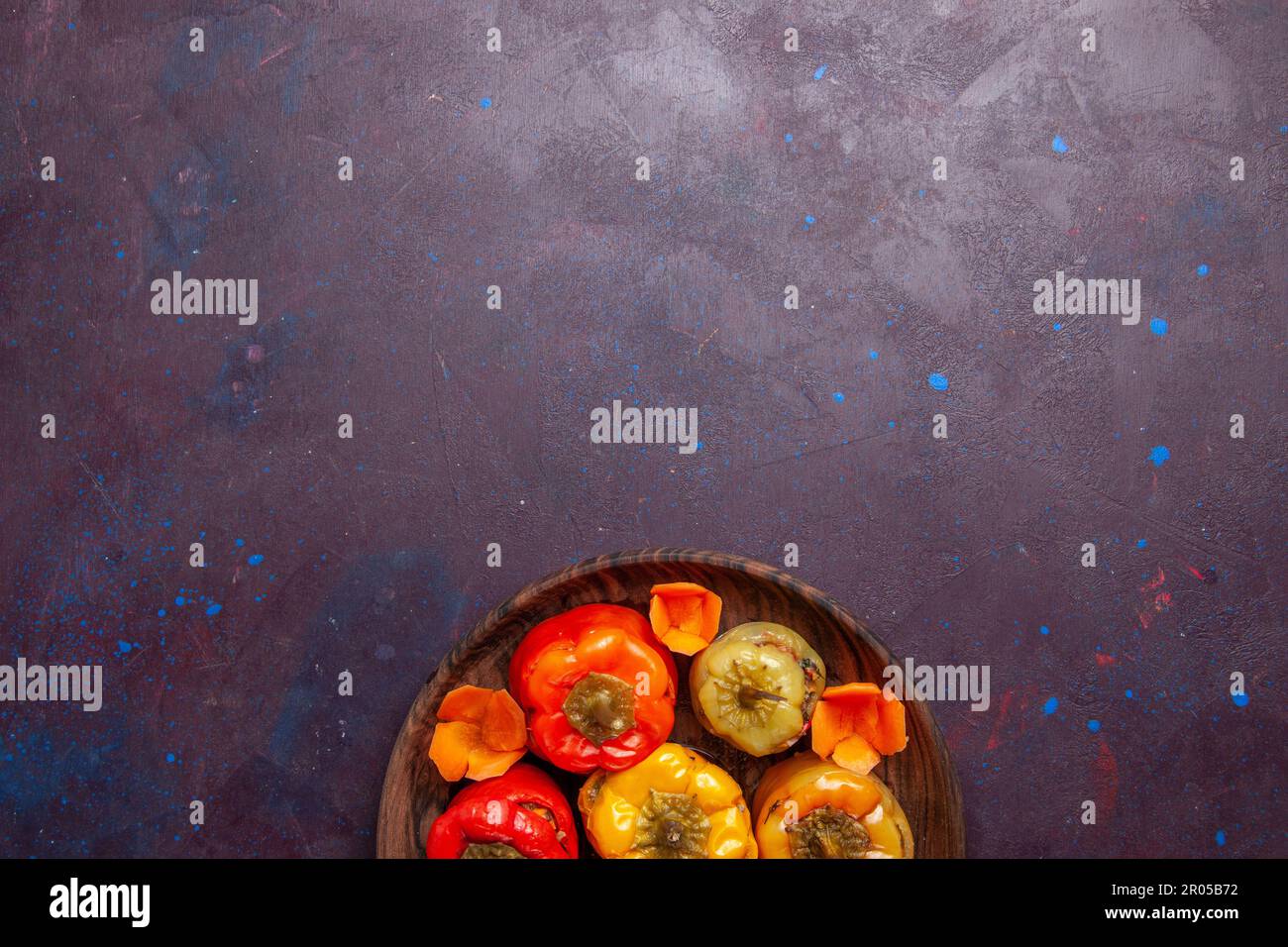 top view cooked bell-peppers with ground meat inside on the grey ...