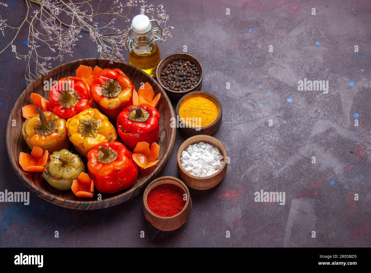 top view cooked bell-peppers with seasonings on dark-grey background ...