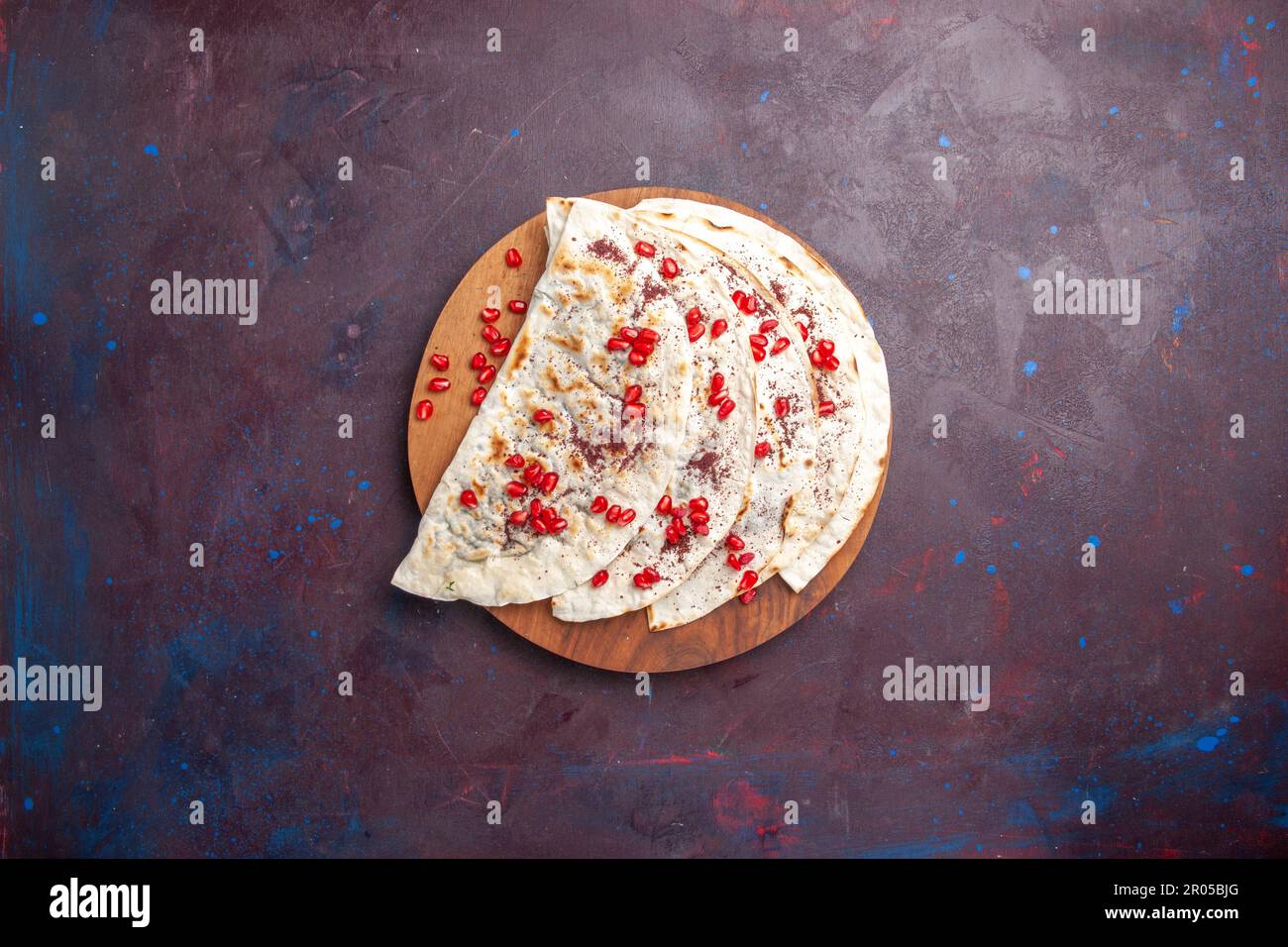 top view delicious meat qutabs pitas with fresh pomegranates on dark ...