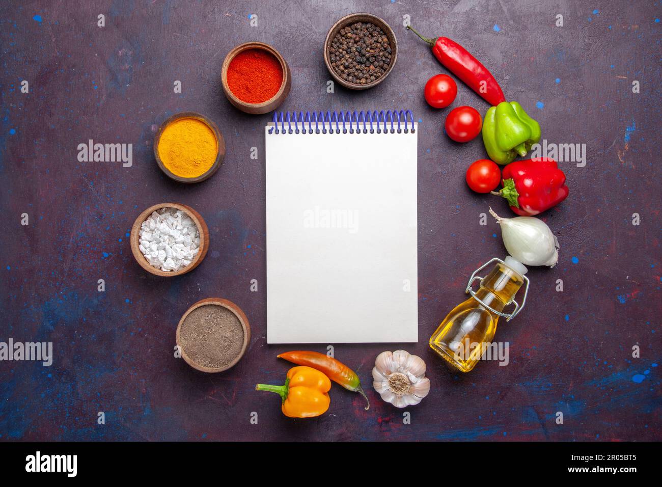 top view different seasonings with oil and vegetables on dark ...