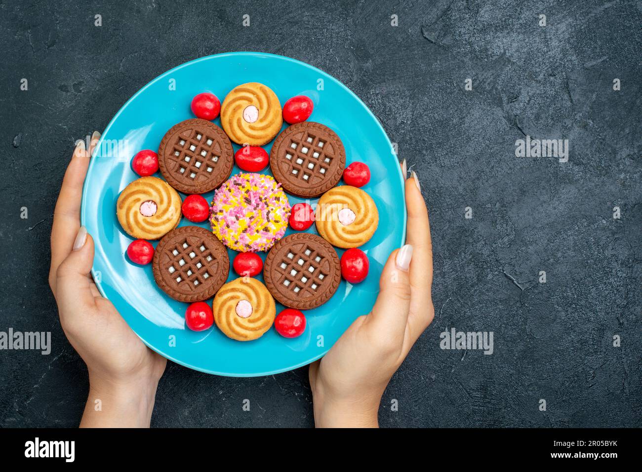 top view different sugar cookies with candies on the grey background ...