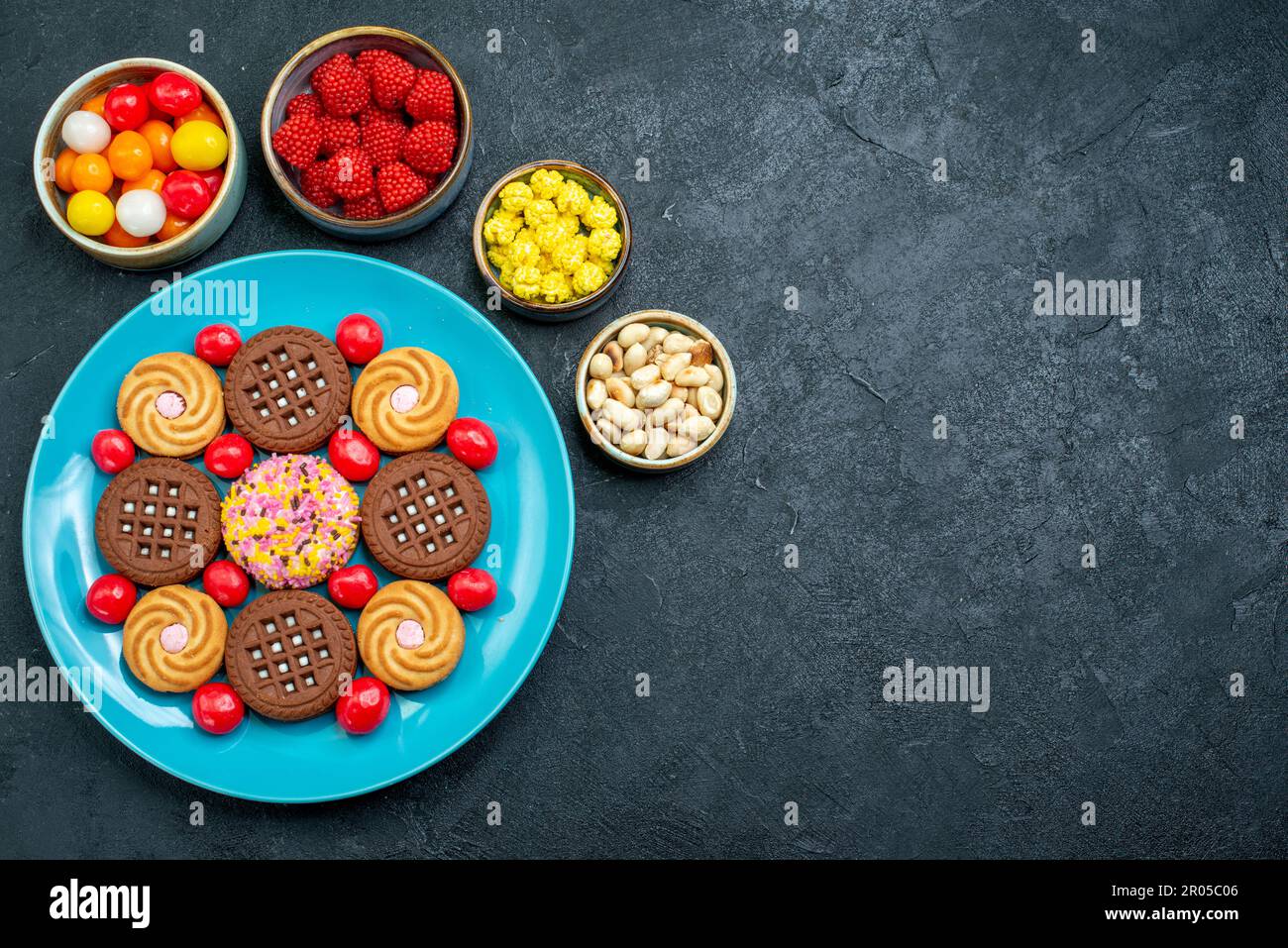 top view different sugar cookies with candies on the grey background ...