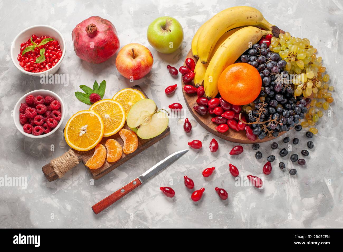 top view fresh fruits composition bananas dogwoods and grapes on a ...