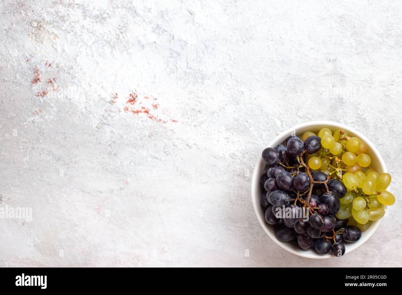 top view fresh grapes inside plate on a light background fruit juicy ...
