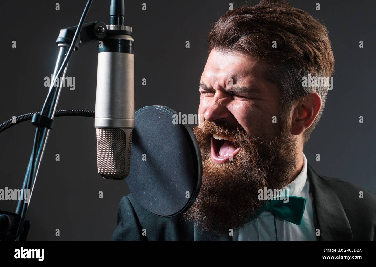 Karaoke singer. Man singing with music microphone. Classical music ...