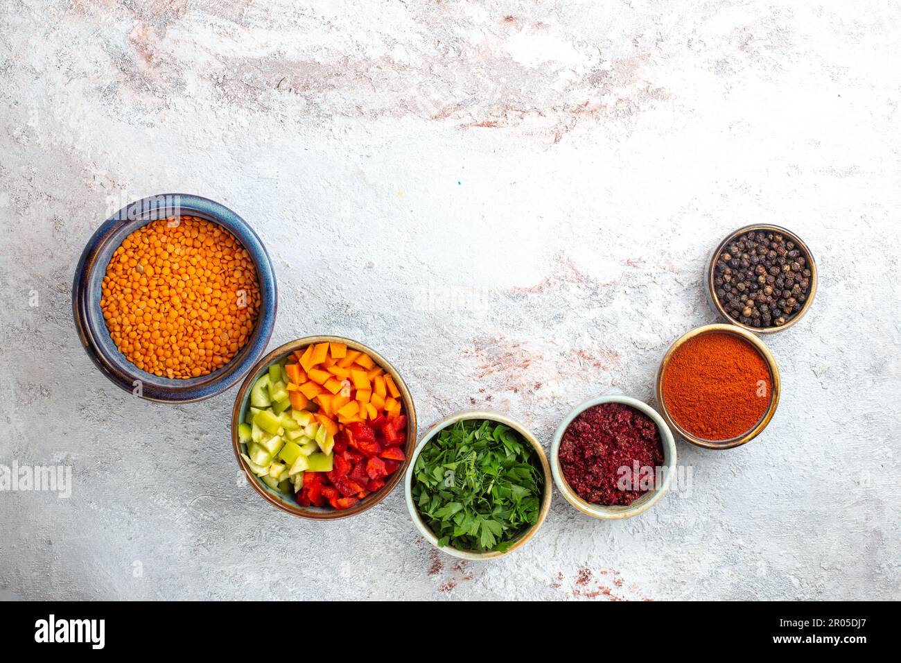 top view raw orange beans with seasonings on light white background ...