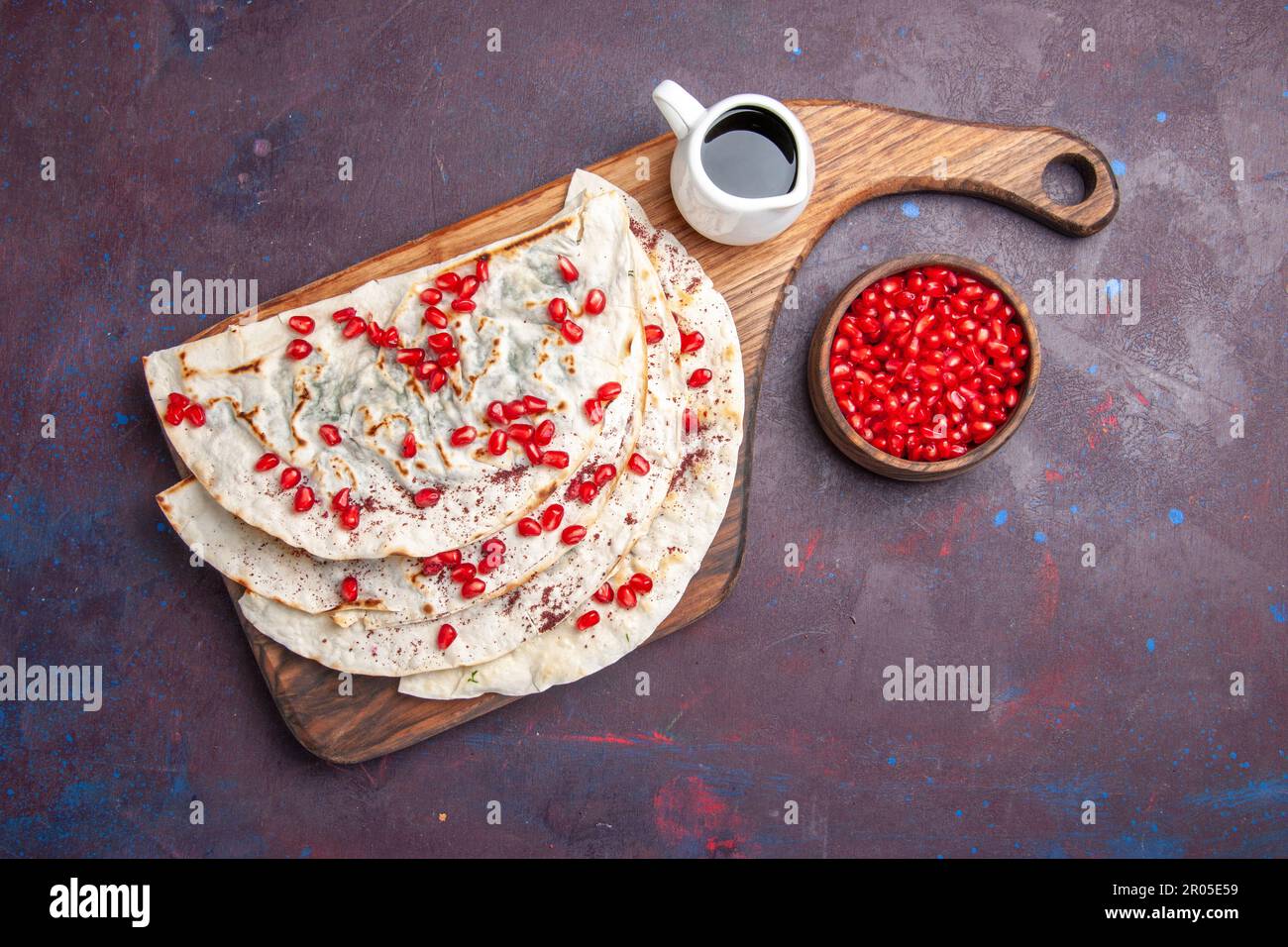 top view tasty meat qutabs pitas with fresh red pomegranates on dark ...