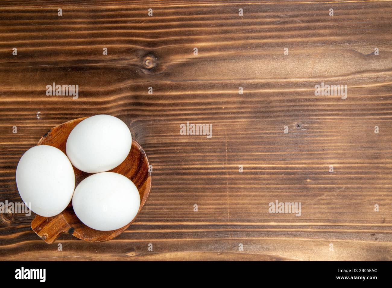 top view whole raw eggs on brown wooden background meal food breakfast ...